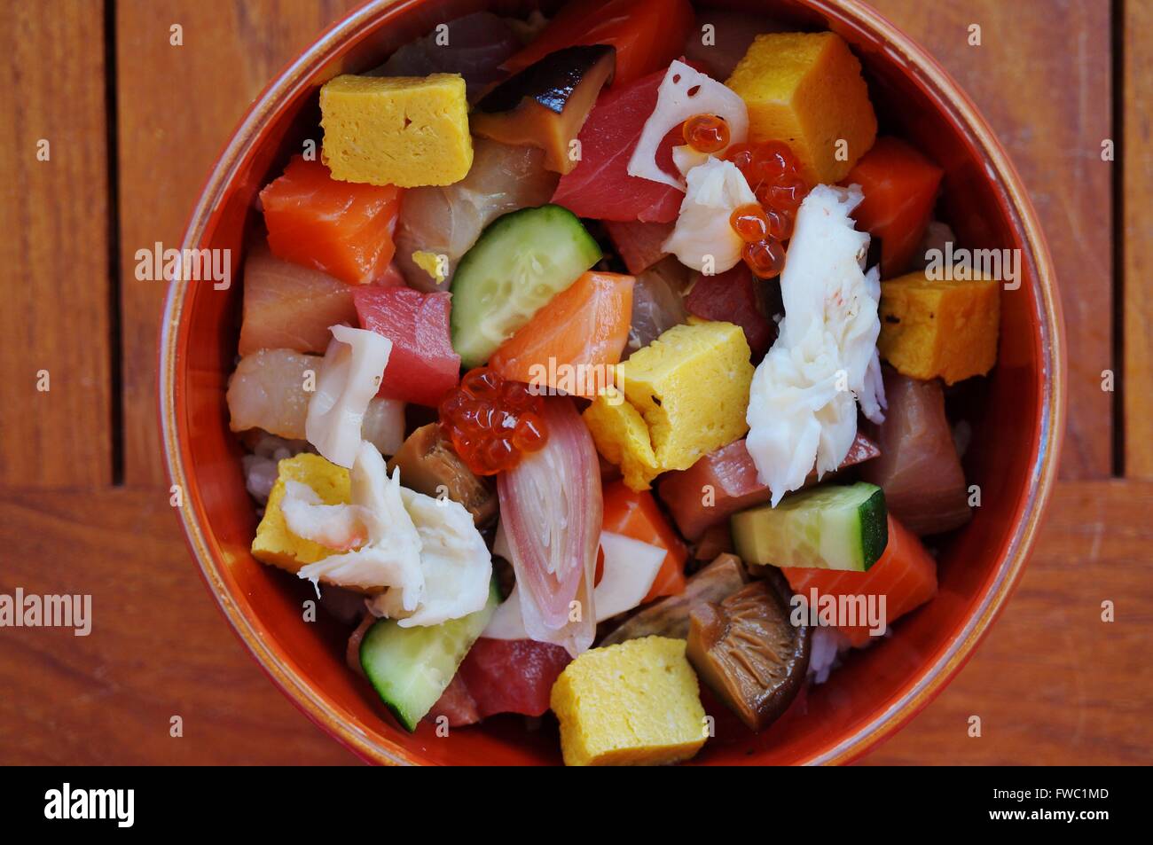 Bowl of chirashi sushi with mixed raw fish and salmon roe over rice ...