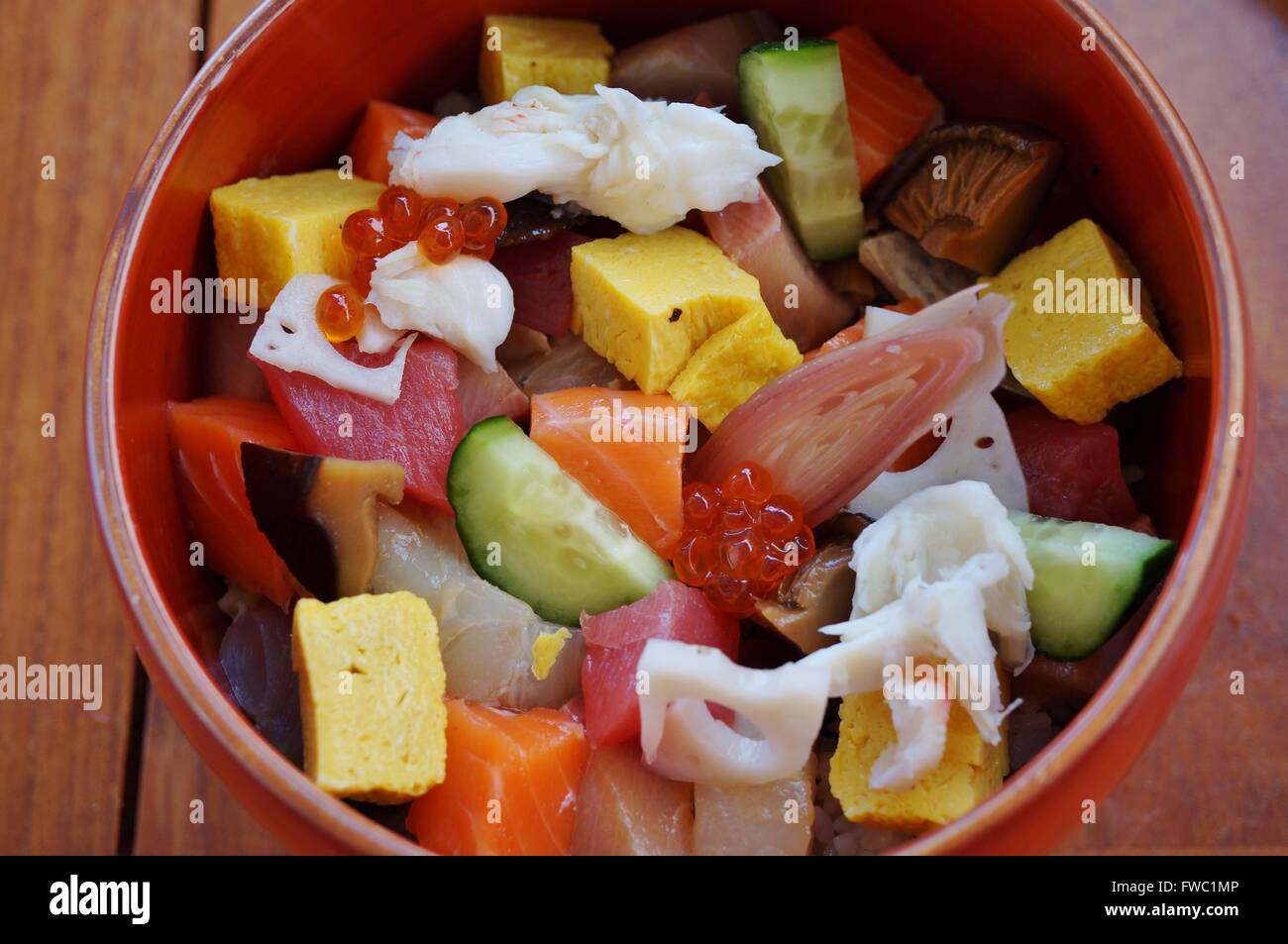 Bowl of chirashi sushi with mixed raw fish and salmon roe over rice ...