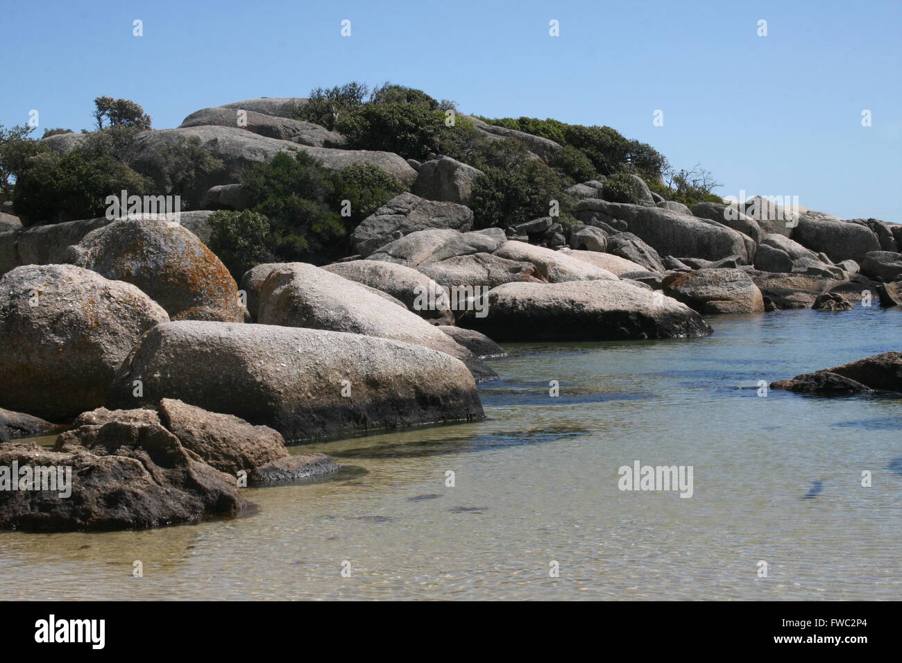 Boulders on a beach Stock Photo - Alamy
