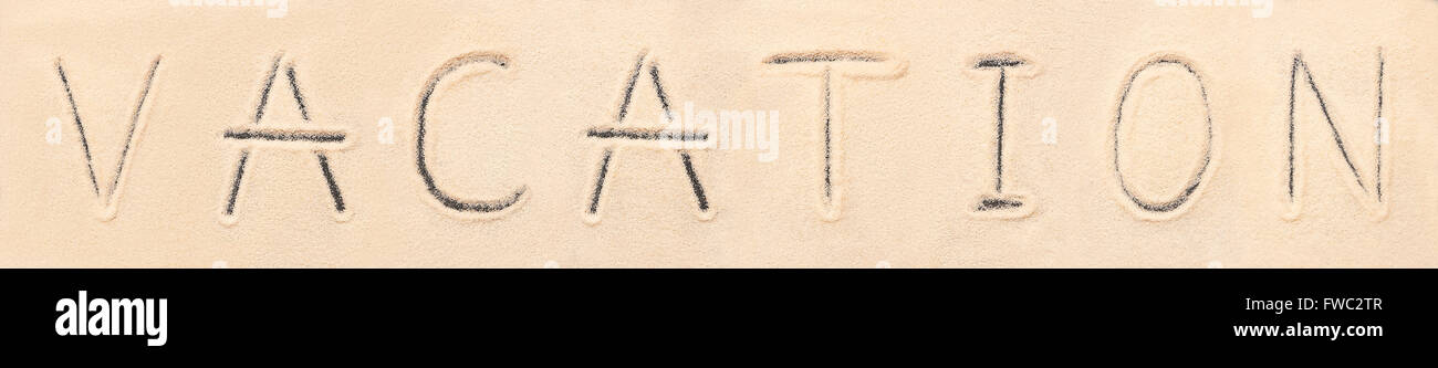 Vacation lettering drawn on sand. Summer beach background Stock Photo ...