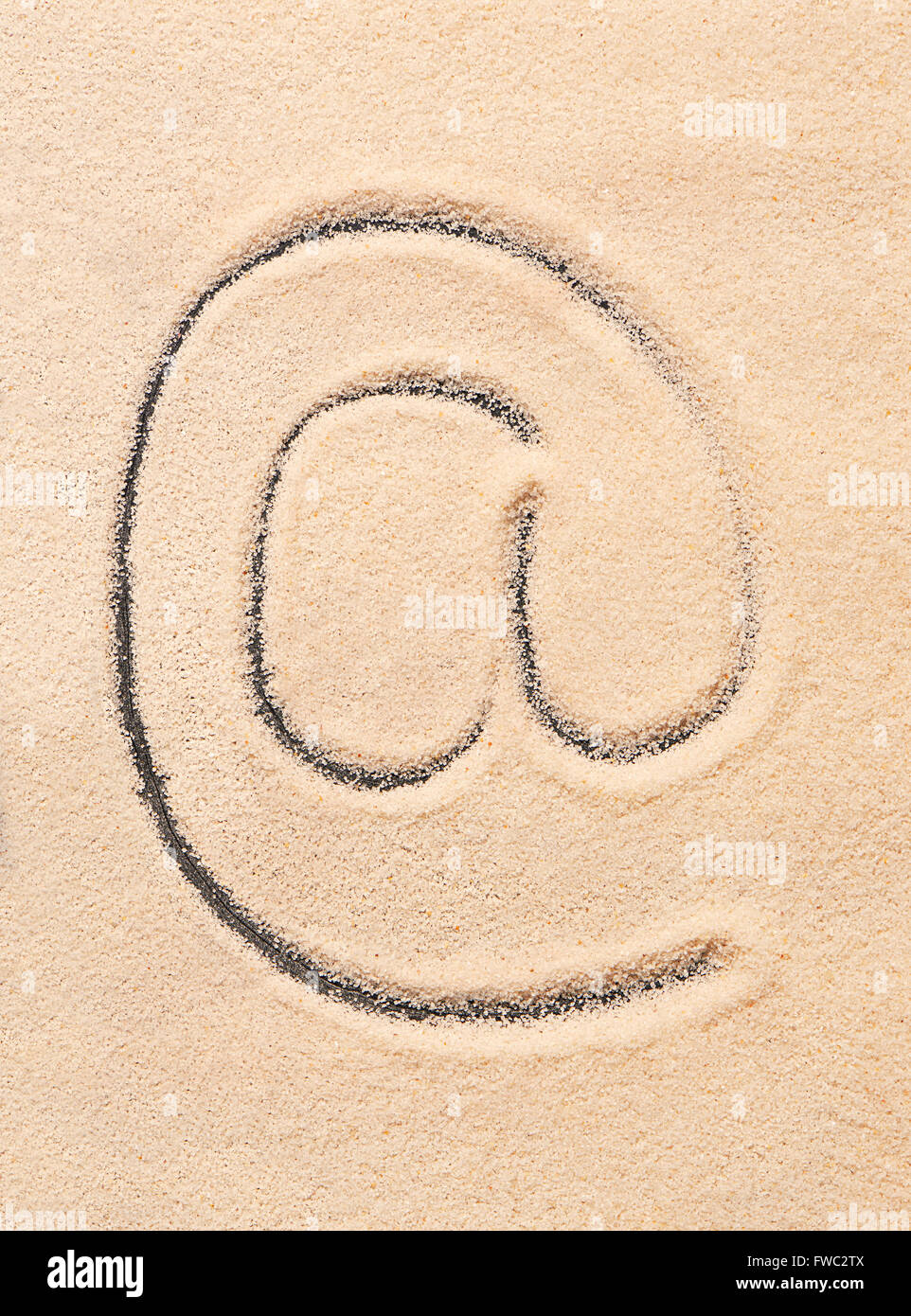 AT symbol, email address icon drawn on sand. Summer beach background ...
