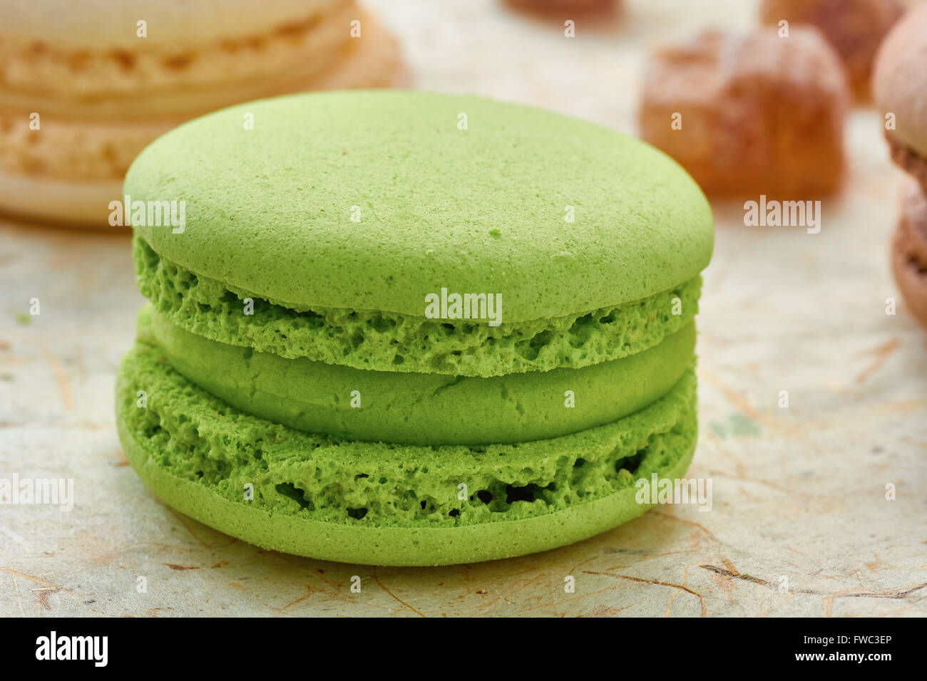 French green macaron on wrapping-paper Stock Photo - Alamy