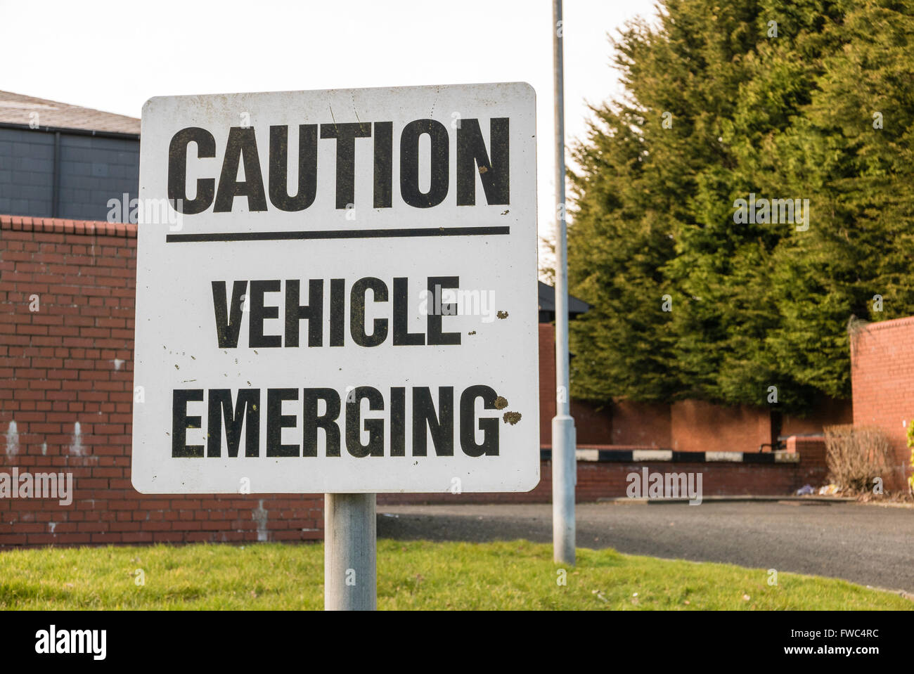Sign warning pedestrians that vehicles may be emerging from an entrance ...