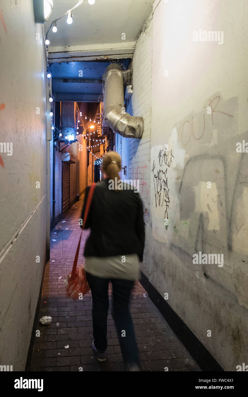 A woman walks through Crown Entry, one of the "Entries" in Belfast ...