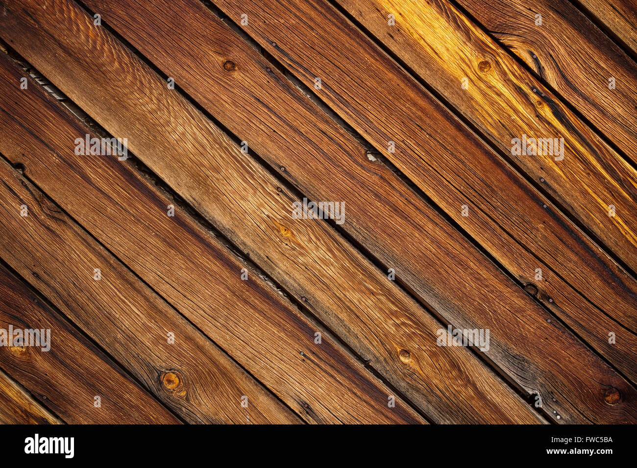 Background of wood boards perpendicular, brown and orange, has a well ...