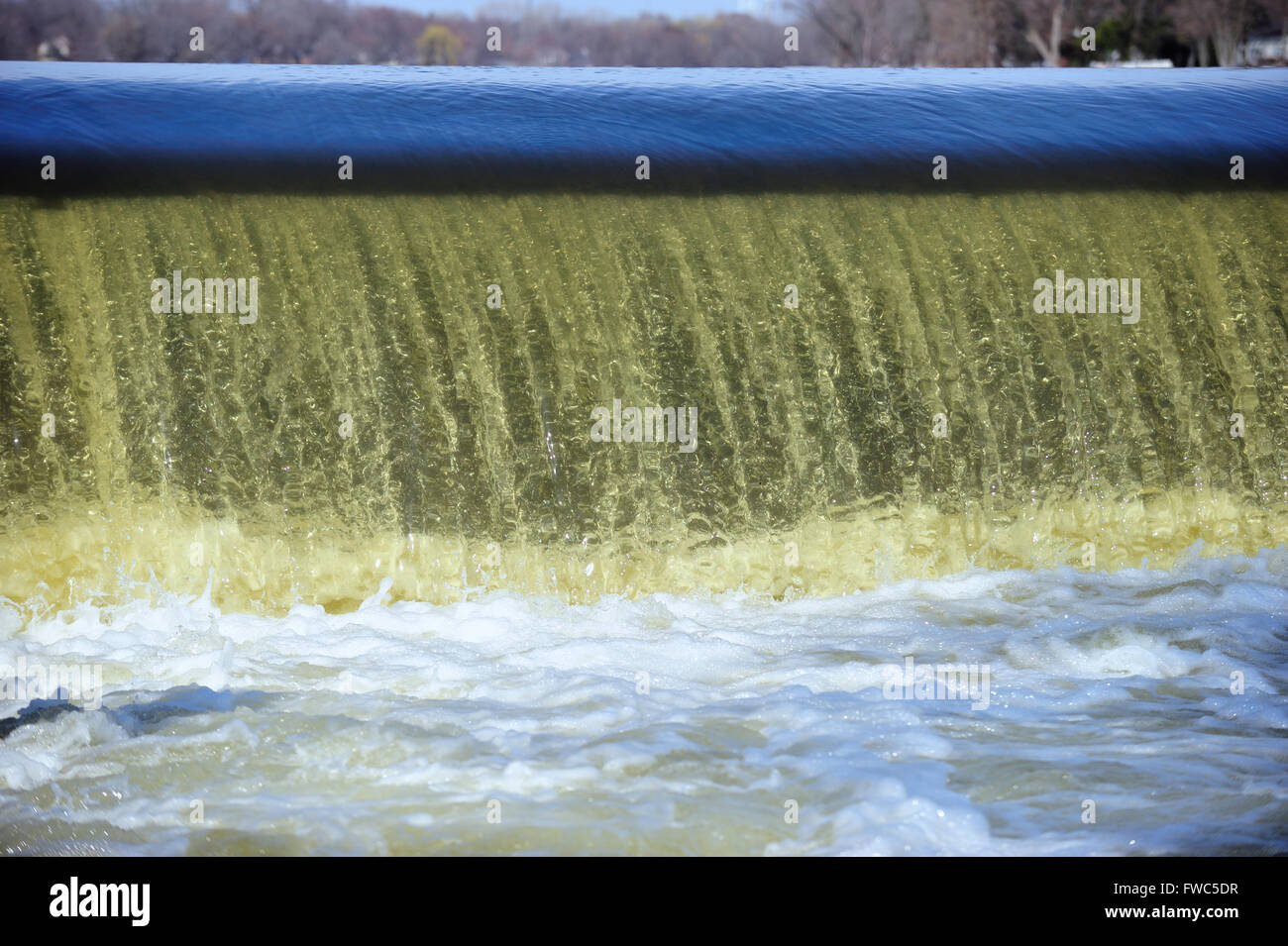 Rushing water pours over a Fox River dam in a swirl of activity. South ...