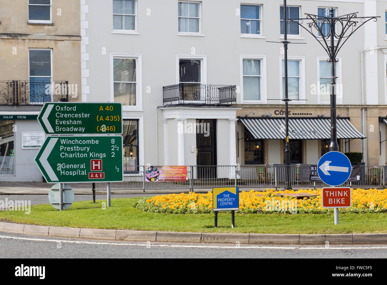 Think bike and driving directional signs on a roundabout in Cheltenham ...