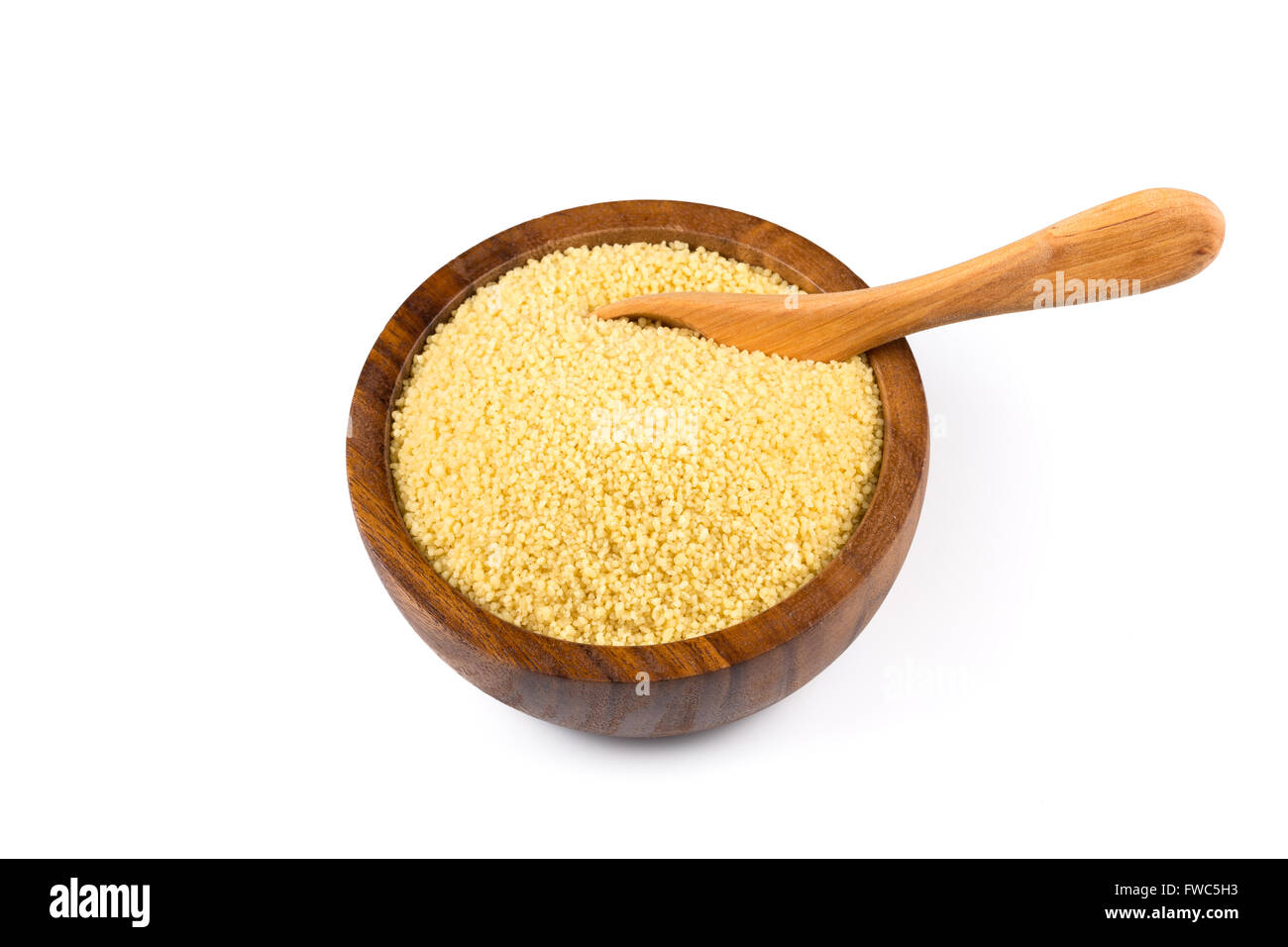 Raw couscous in a wooden bowl on white background Stock Photo - Alamy