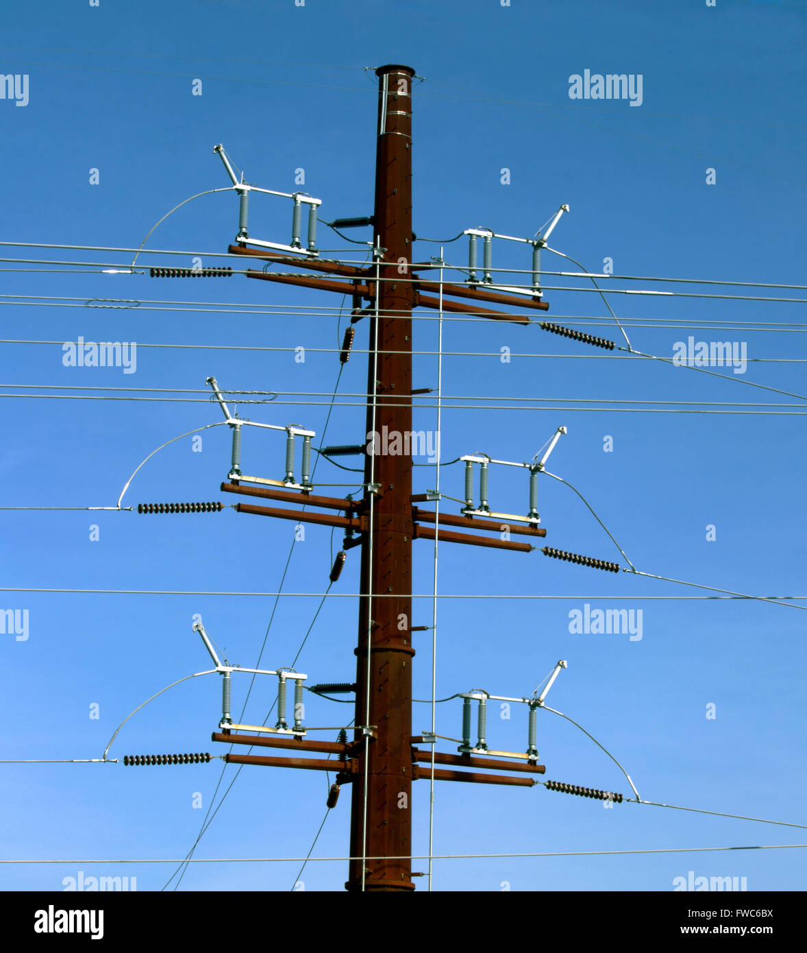 Electric power grid transmission tower against clear blue sky Stock ...