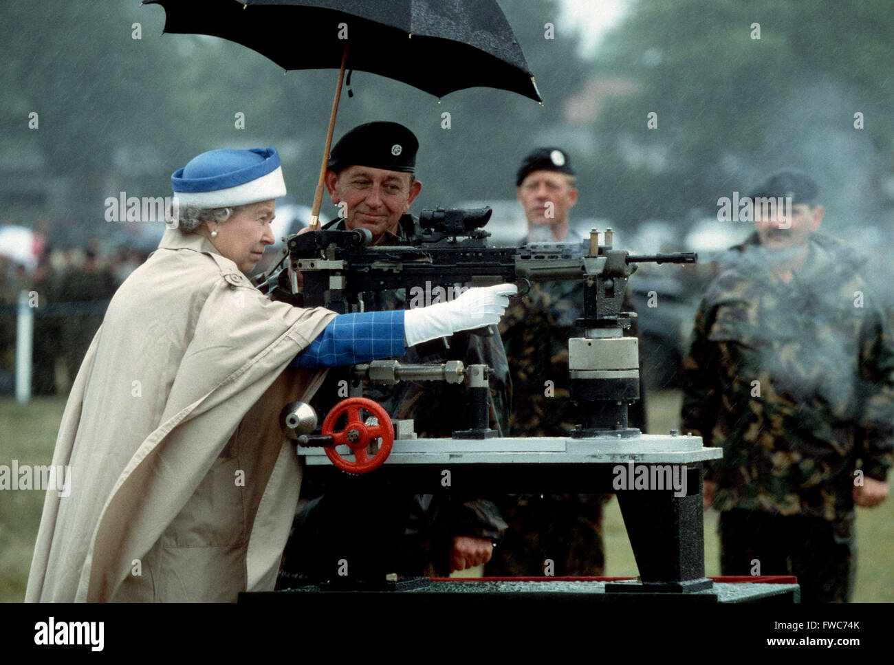 HM Queen Elizabeth II fires a rifle during a visit to the Army rifle ...