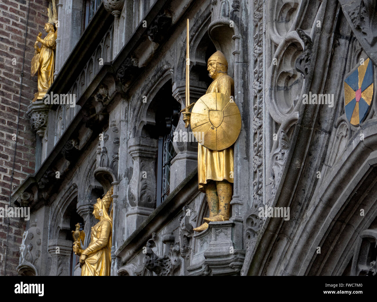 Guilded stone statues at the Basilica of the Holy Blood in Bruges ...