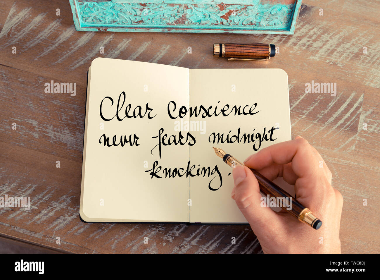 Retro effect and toned image of a woman hand writing on a notebook ...