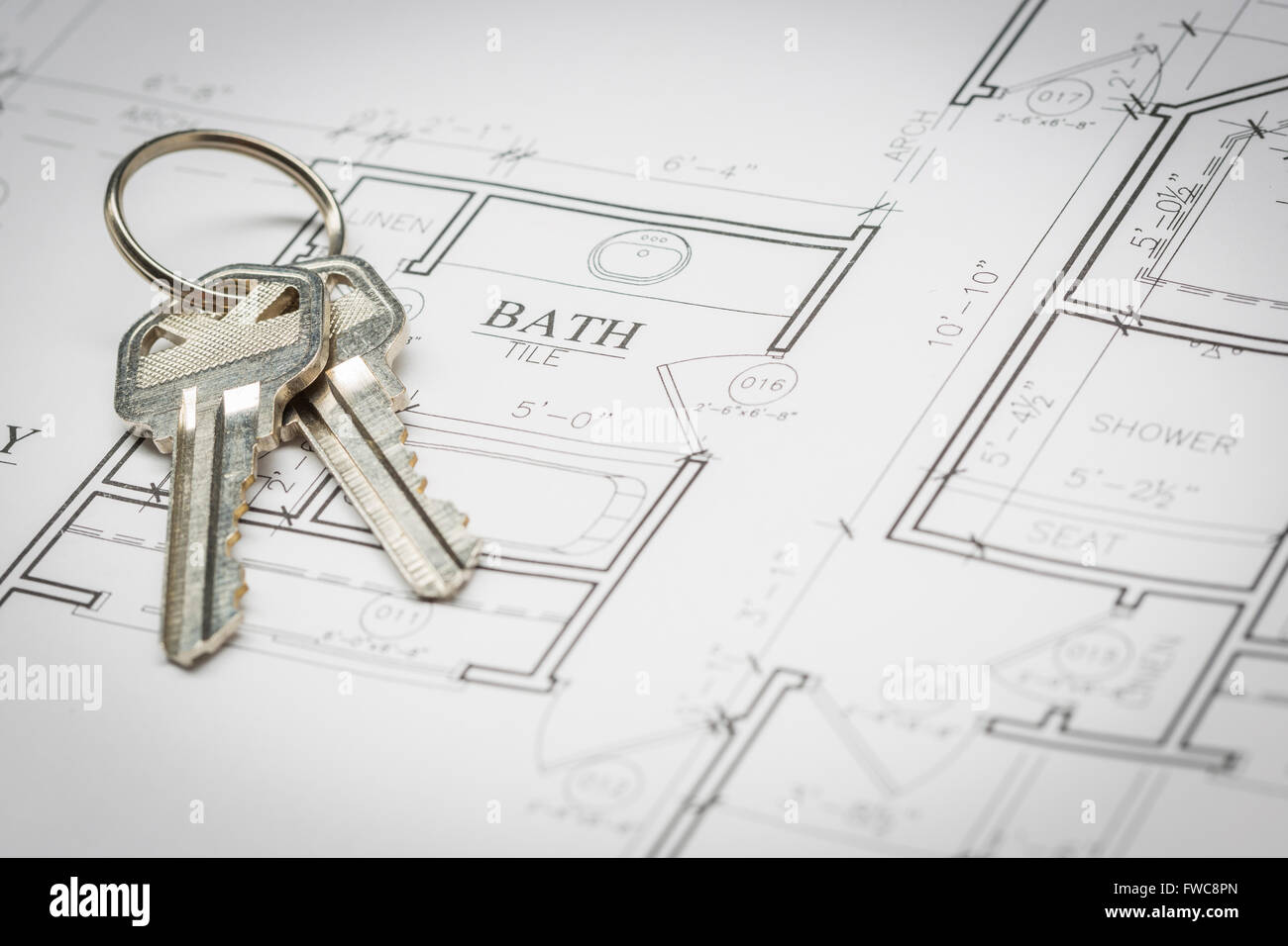 Set Of New House Keys Resting On Custom House Plans Stock Photo - Alamy
