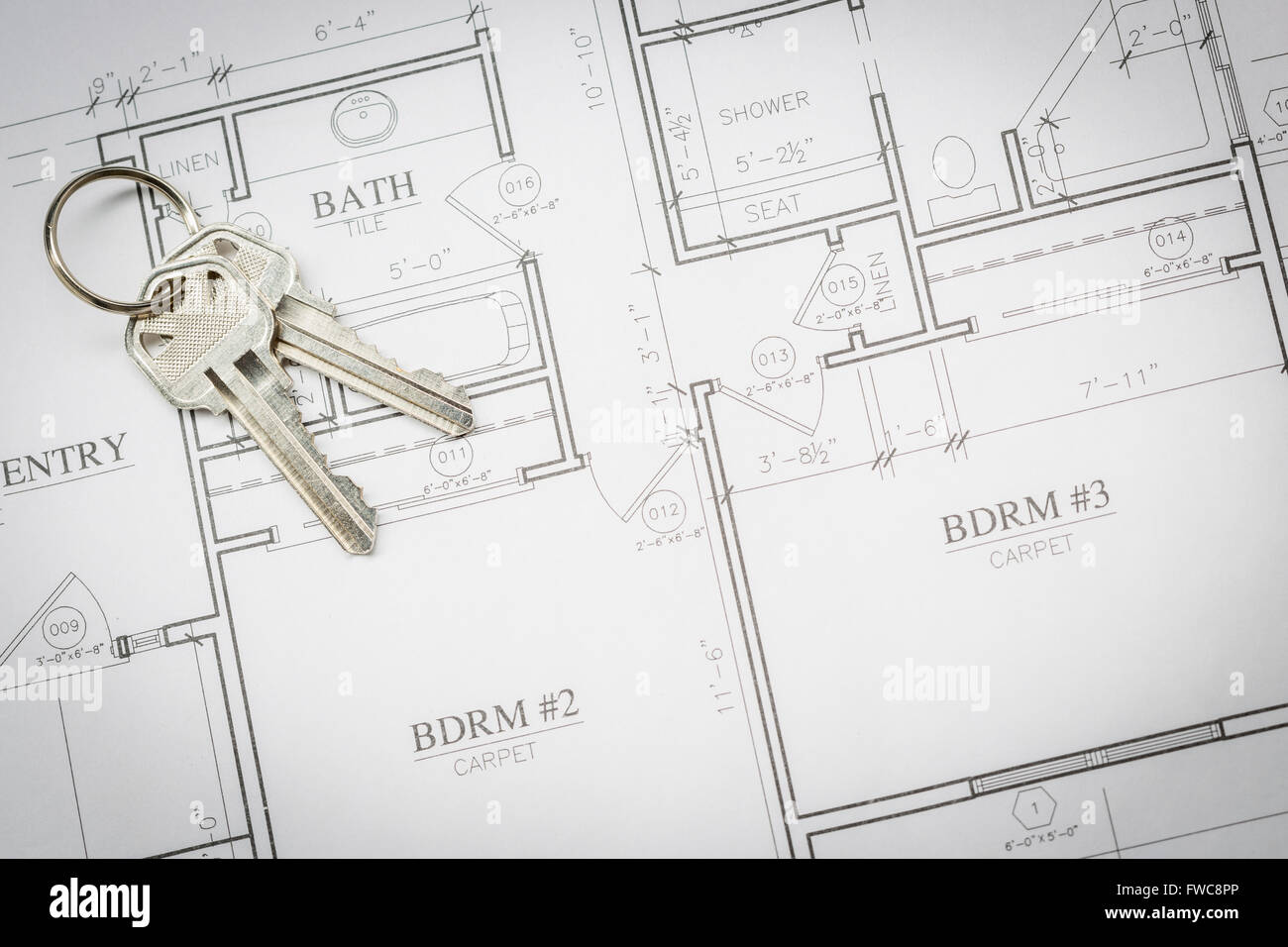 Set Of New House Keys Resting On Custom House Plans Stock Photo - Alamy