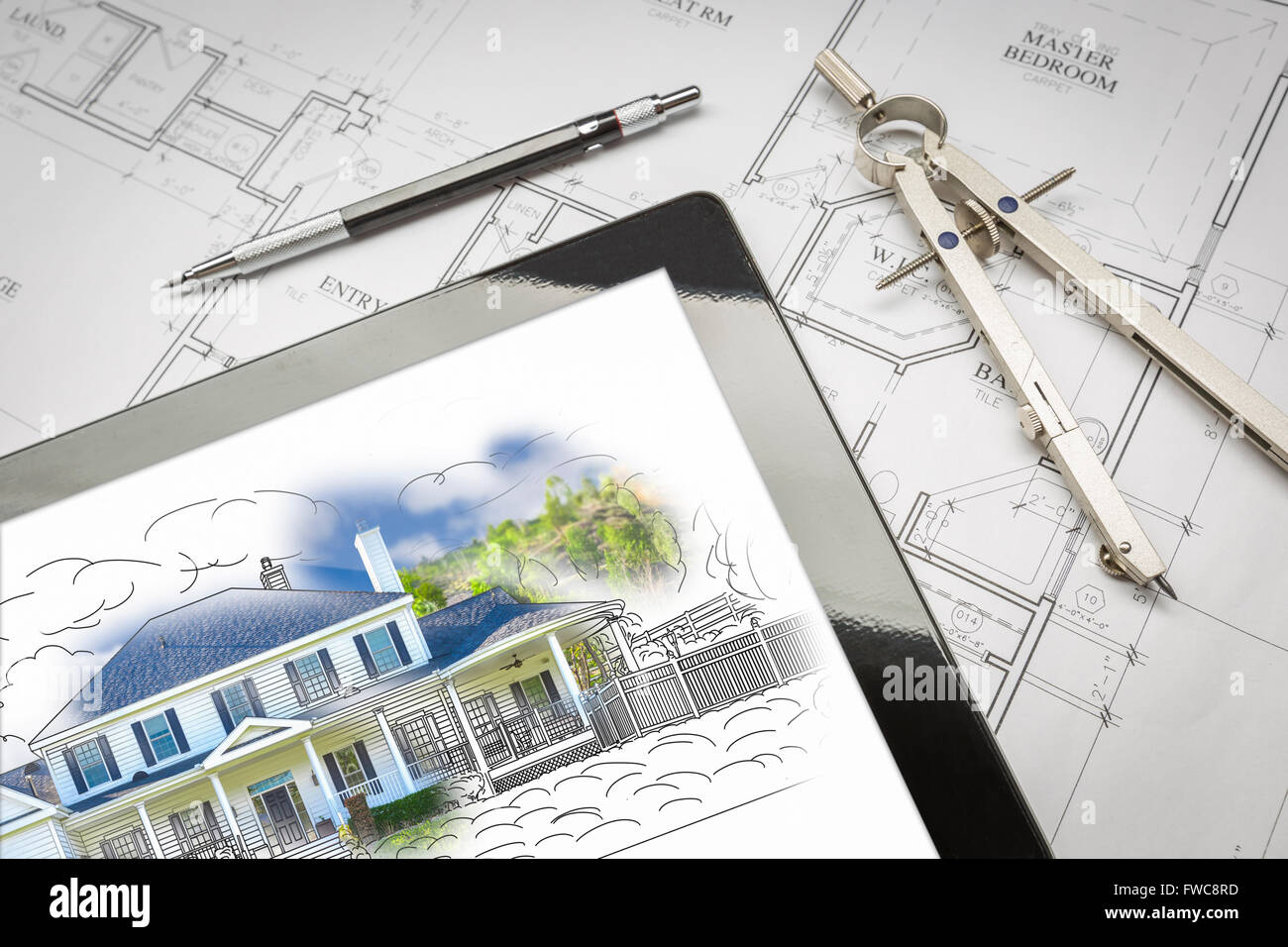 Computer Tablet Showing House Illustration Sitting On House Plans With ...