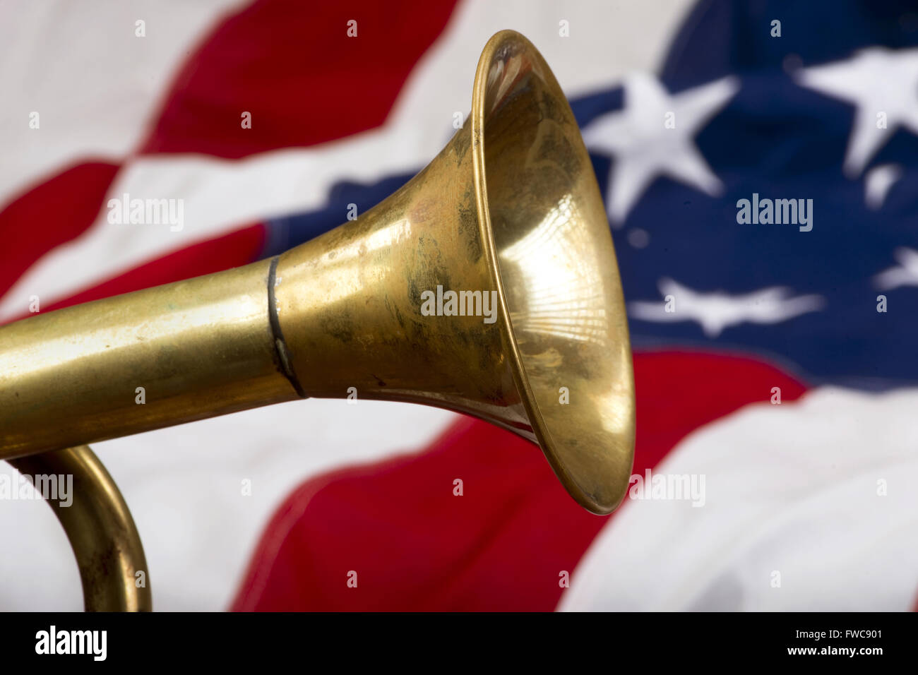 Brass bugle on a American flag Stock Photo - Alamy