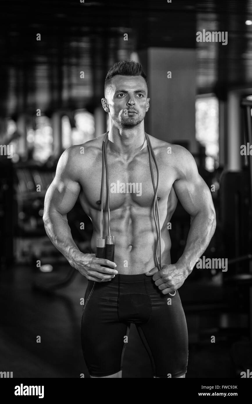 Portrait Of A Physically Fit Man Posing With Jumping Rope In Modern ...