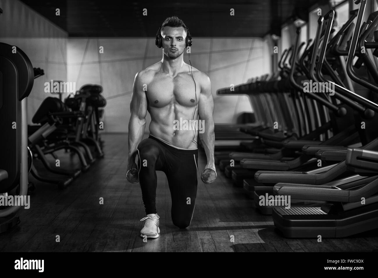Young Man Working Out Legs With Dumbbells - One Of The Best ...