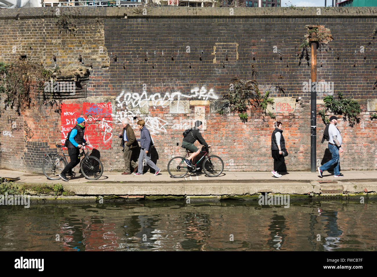 People walking along the Regent's Canal towpath in London's King's ...
