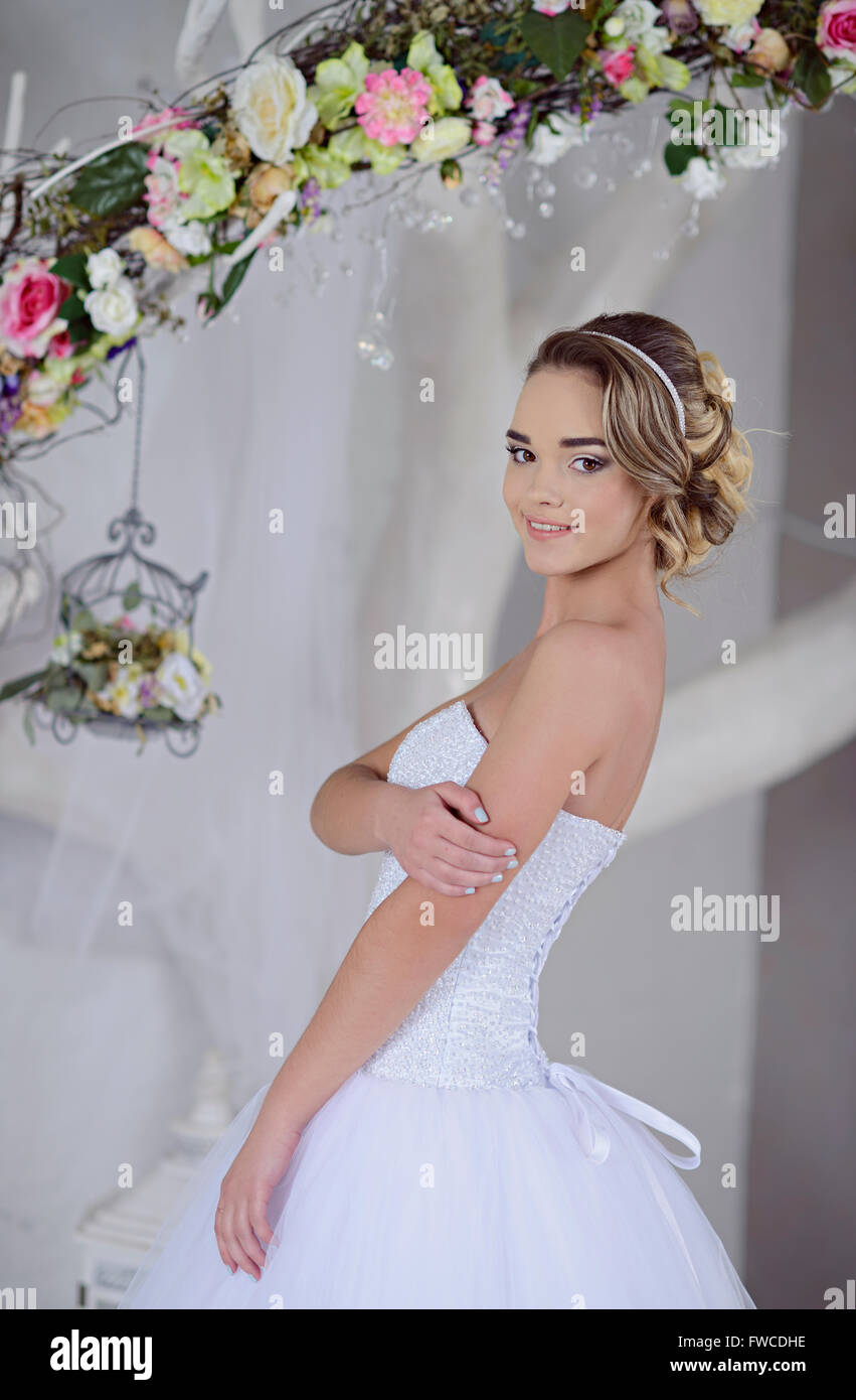 Beauty bride in bridal gown indoors. Beautiful model girl in a white ...