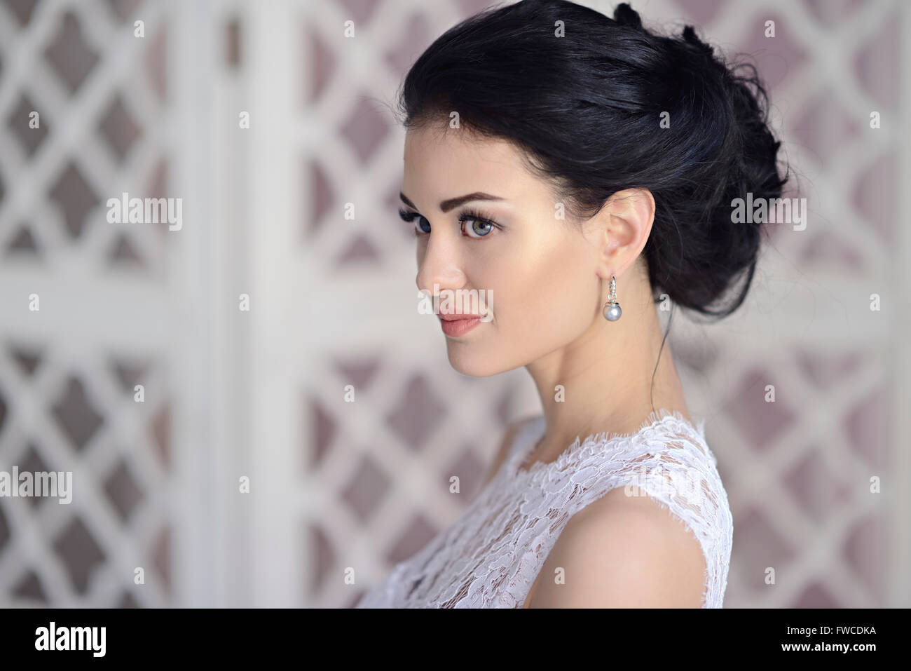 Beauty bride in bridal gown indoors. Beautiful model girl in a white ...