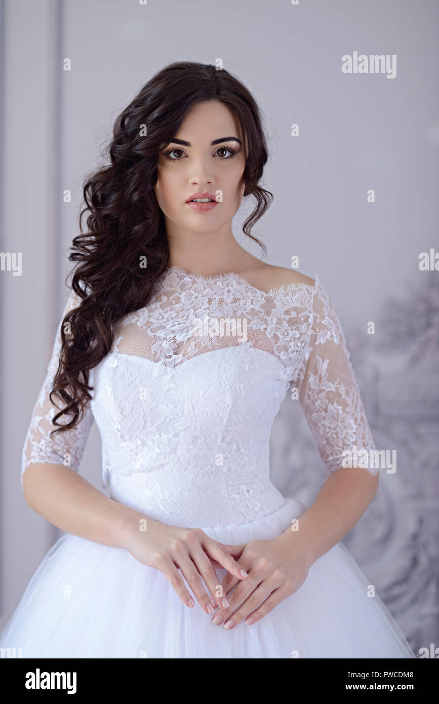 Beauty bride in bridal gown indoors. Beautiful model girl in a white ...