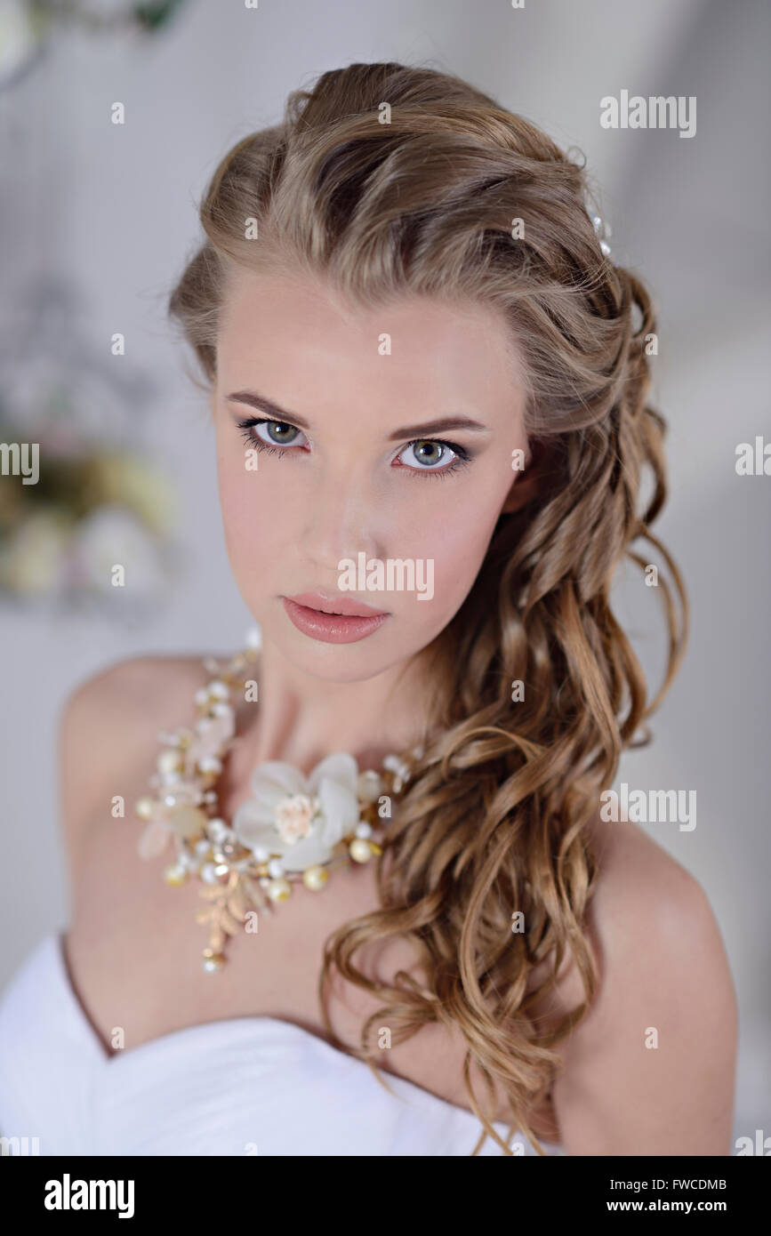 Beauty bride in bridal gown indoors. Beautiful model girl in a white ...