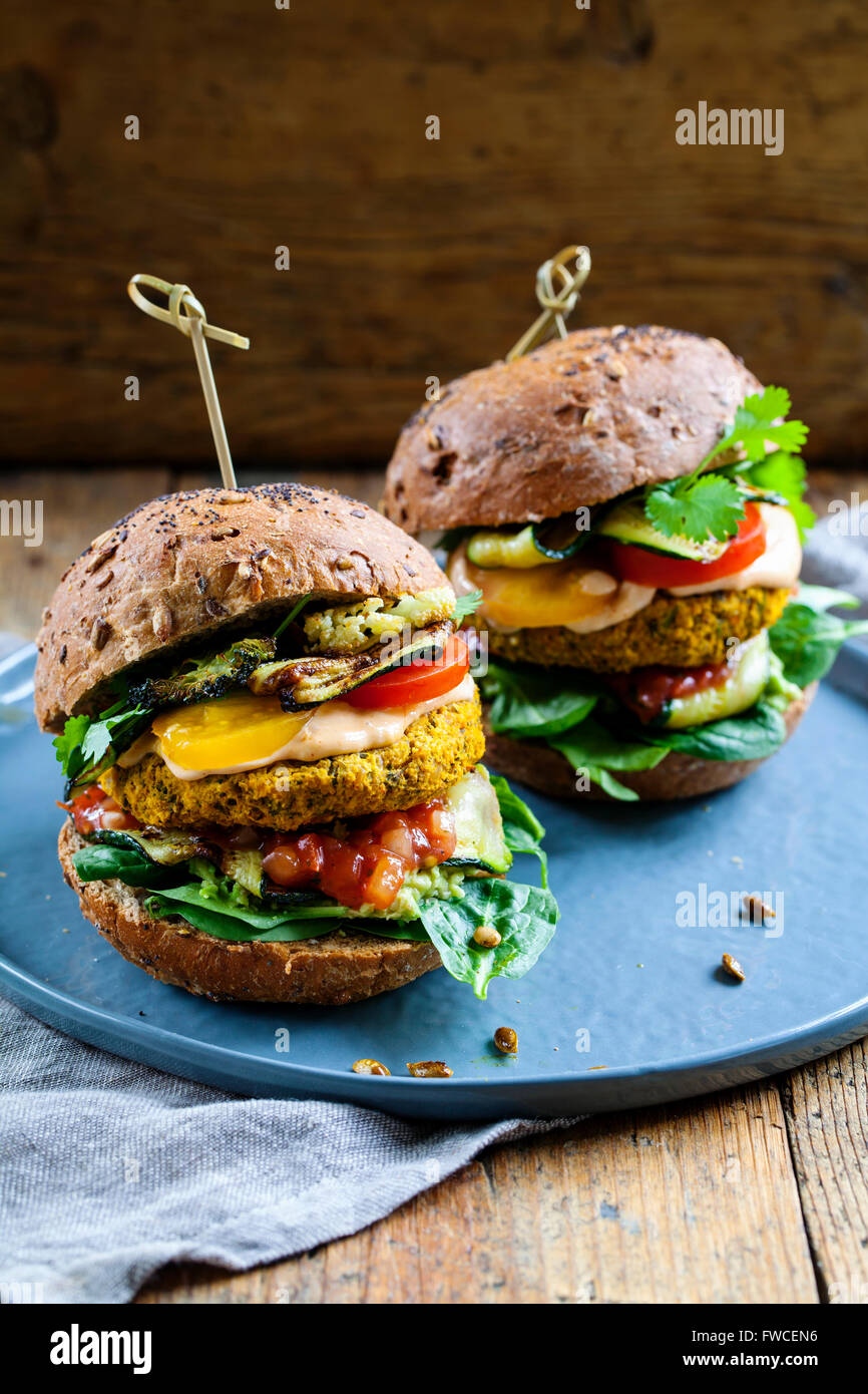 Butternut squash and chickpeas burger with tomato salsa, spinach, roast ...