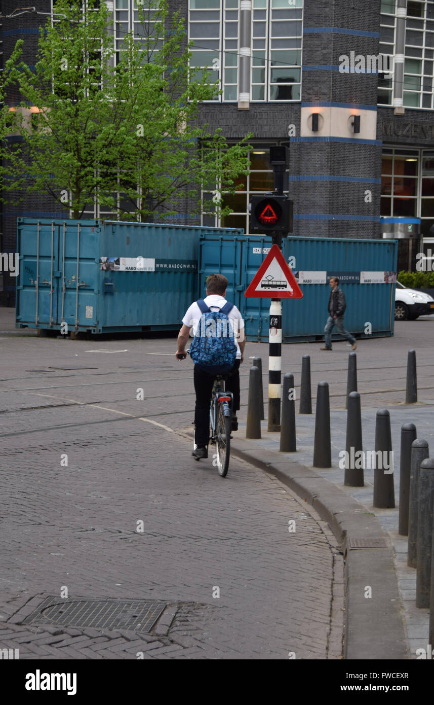 Cyclist waiting a a tram level crossing Stock Photo - Alamy