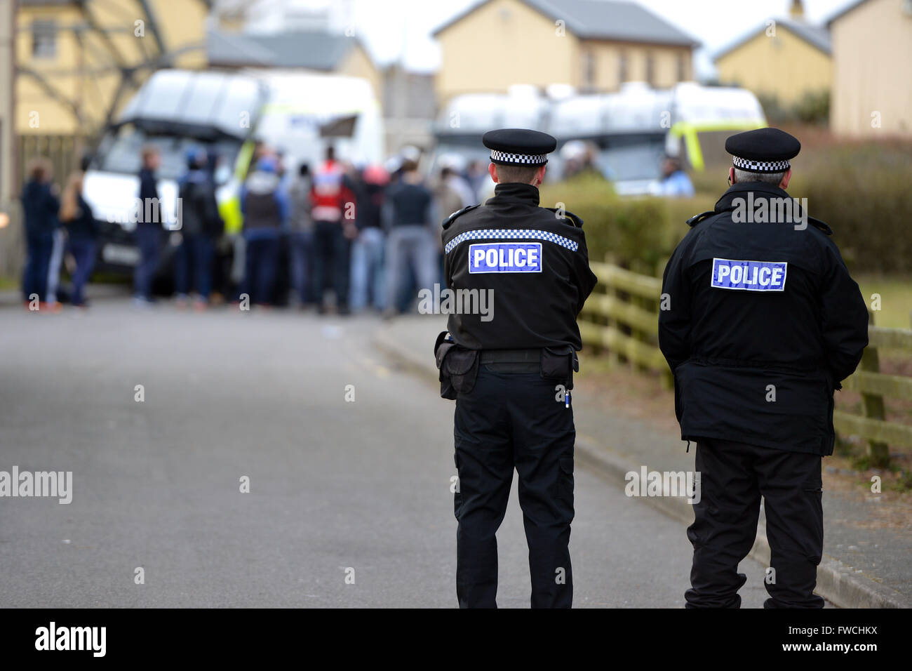 Police officers observe crowd Stock Photo - Alamy