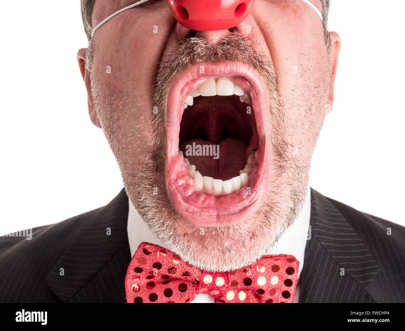 Closeup photograph of a man in a business suit with a red rubber nose ...