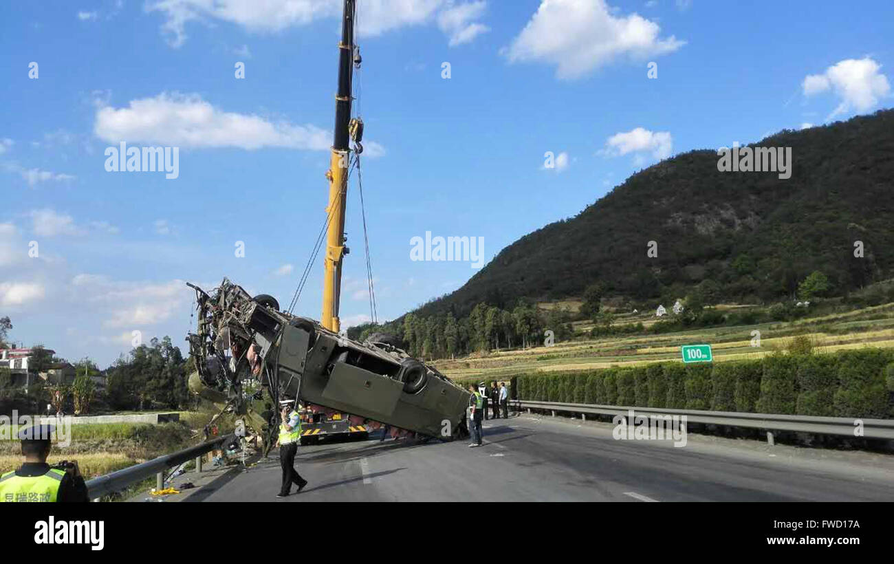 Kunming. 4th Apr, 2016. A crane lift a crashed coach on the highway ...