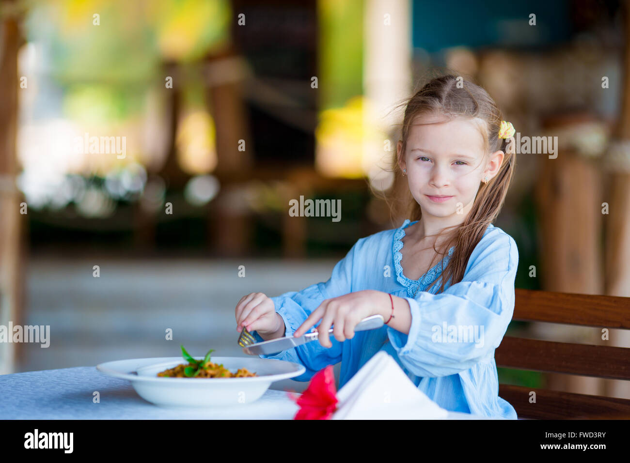 Adorable little girl having lunch at outdoor cafe Stock Photo - Alamy