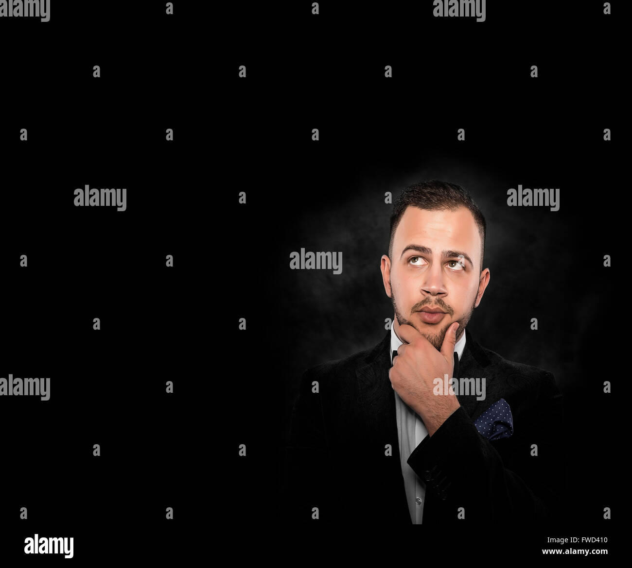 Young handsome man in black suit thinking or dreaming Stock Photo - Alamy