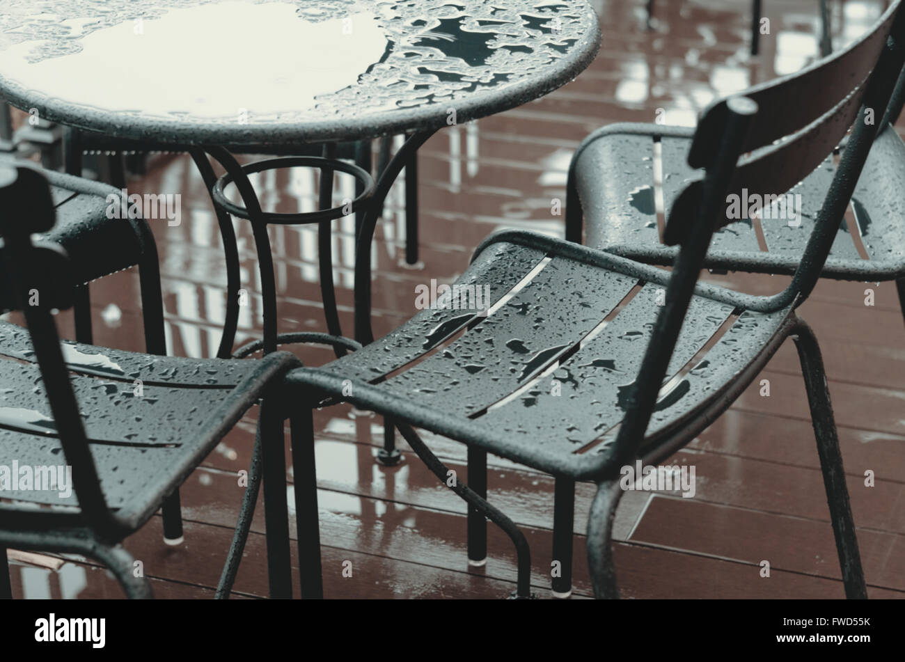 Black Chair In The Rain Is Outdoor at Balcony Stock Photo - Alamy