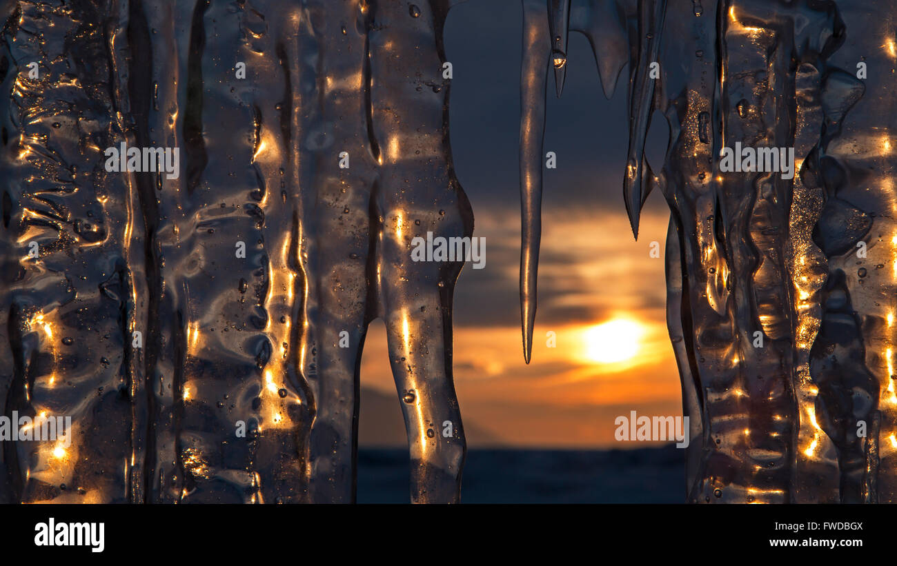 Setting sun is reflected in icicles Stock Photo - Alamy