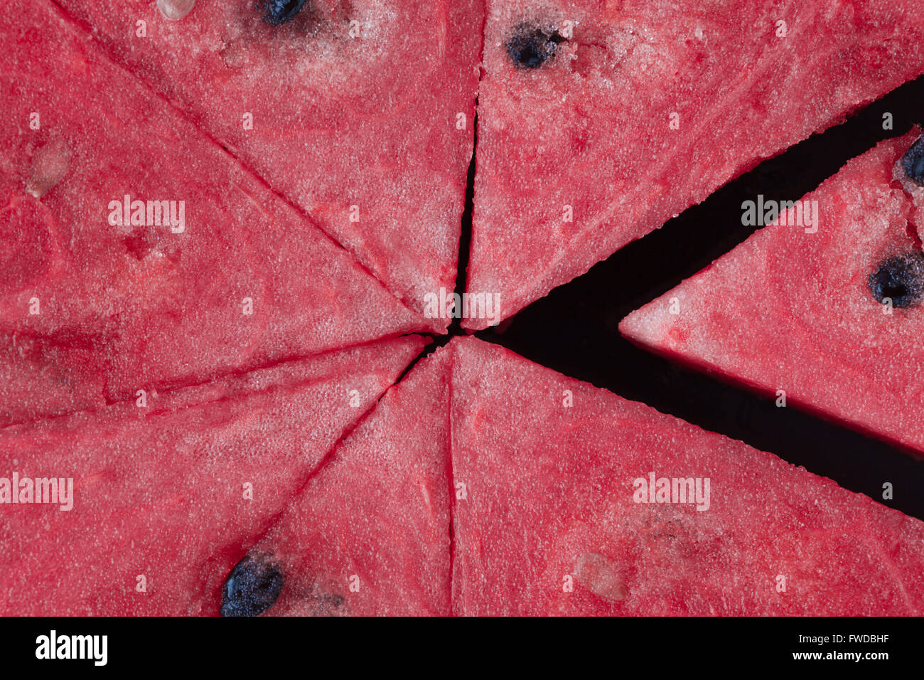 Triangle shaped watermelon slices on black bakcground extreme closeup ...