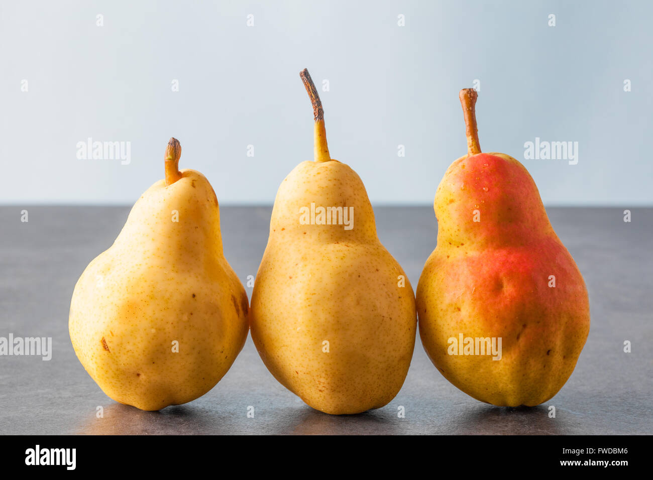 Three whole yellow Corella pears Stock Photo - Alamy