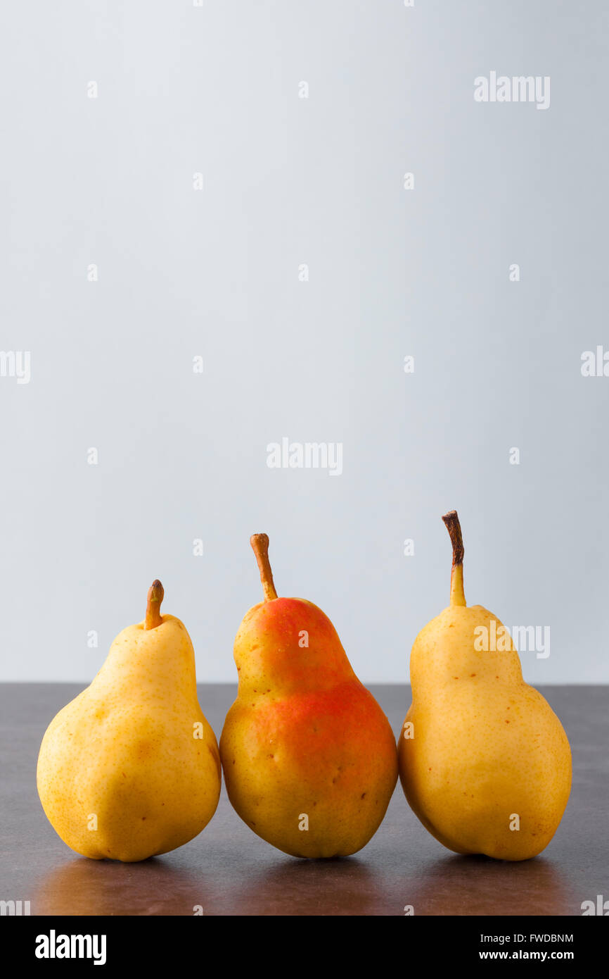 Three whole yellow Corella pears. Vertical image with copy space Stock ...