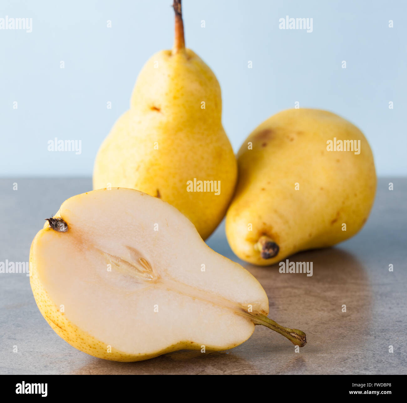 Whole and halved yellow Corella pears Stock Photo - Alamy
