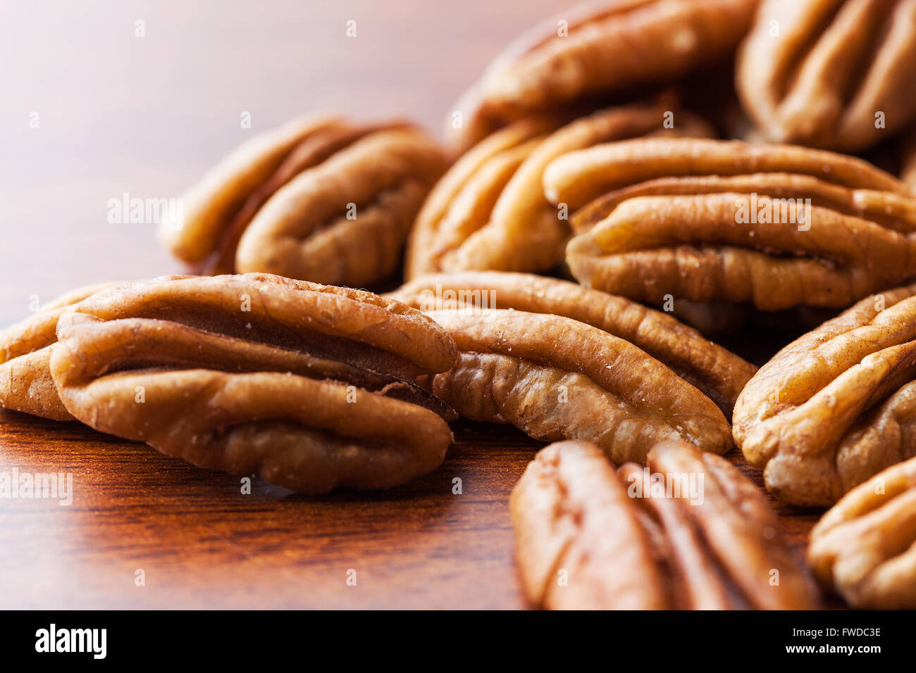 Pecans on wooden table extreme closeup with copy space. Shallow depth ...