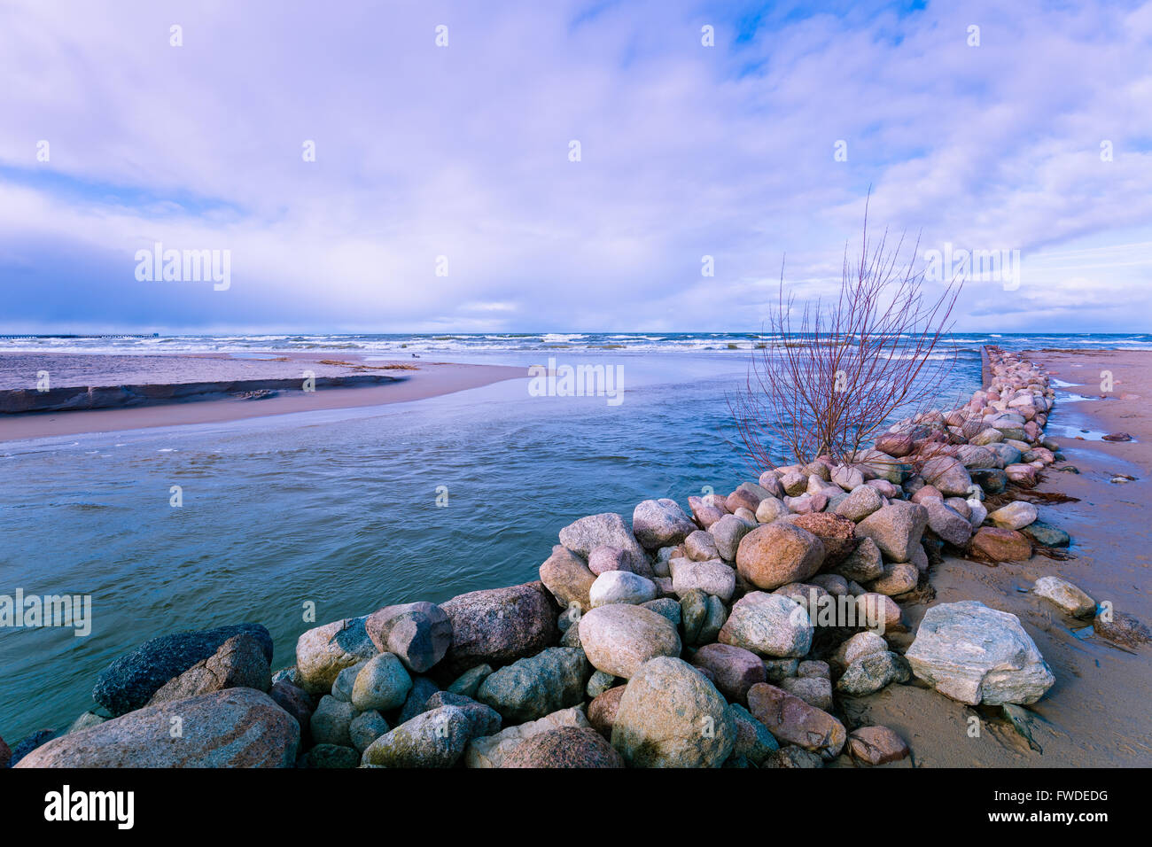 Delta in the daytime. Rocky bank of river. The river flows into the sea ...
