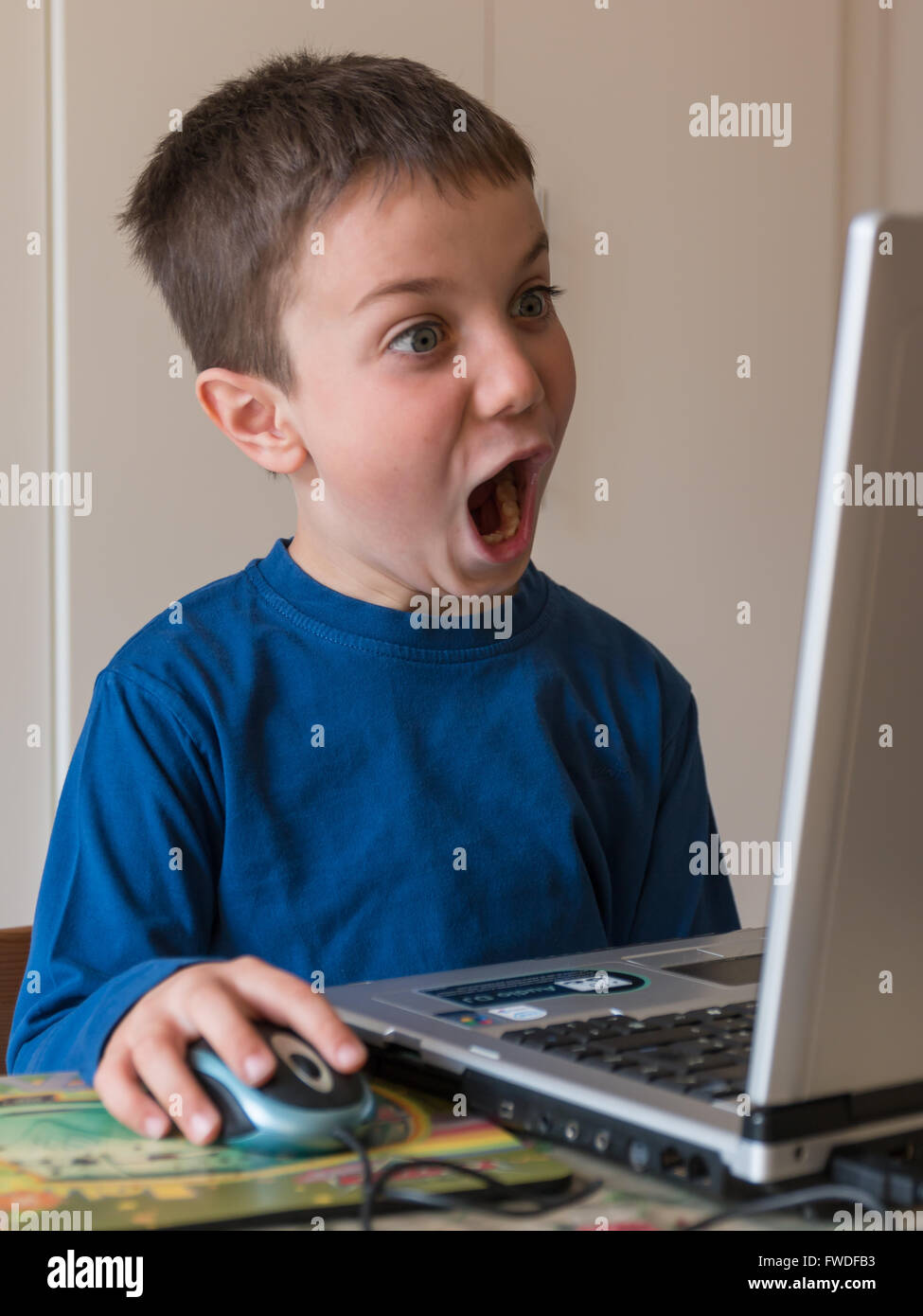 Surprised Child With Touch Screen Laptop Stock Photo - Alamy