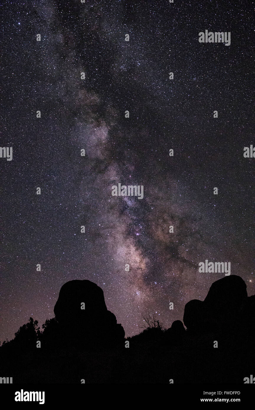 The milky way and galactic core rising above two giant silhouetted ...