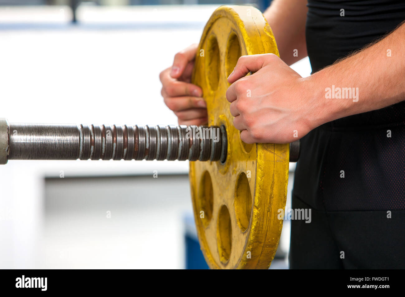 Male hands lifting heavy barbell at gym Stock Photo - Alamy