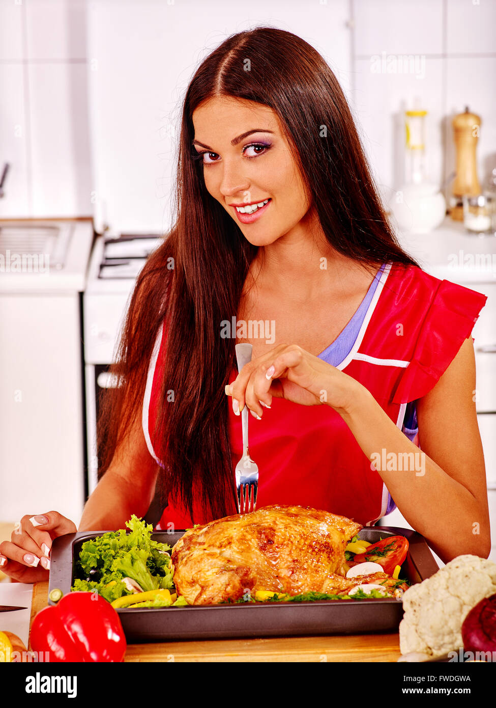Woman cooking chicken at kitchen Stock Photo - Alamy