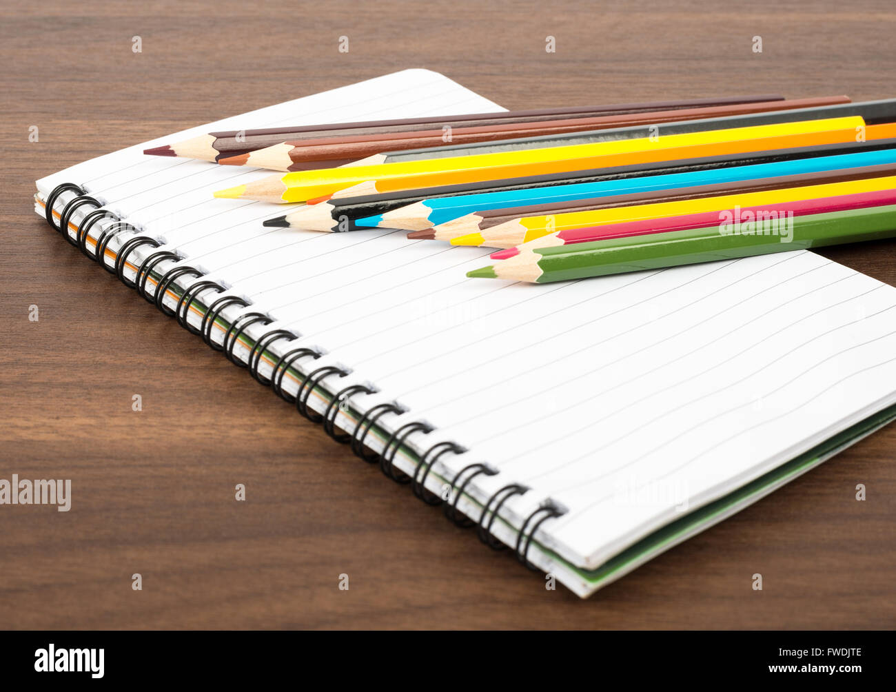 Notebook with crayons Stock Photo - Alamy