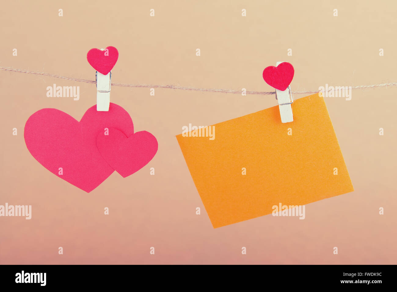 Cut out paper hearts fixed on a rope with clothespins Stock Photo - Alamy