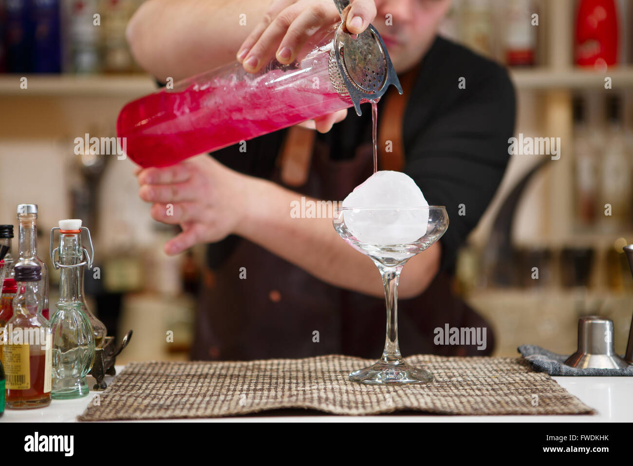 barman pouring a pink cocktail drink Stock Photo - Alamy