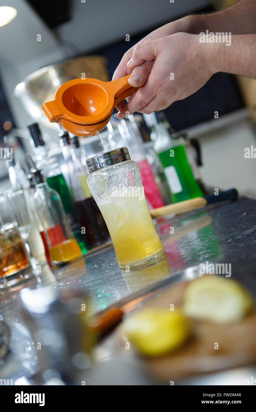 Bartender is straining cocktail in a glass Stock Photo - Alamy